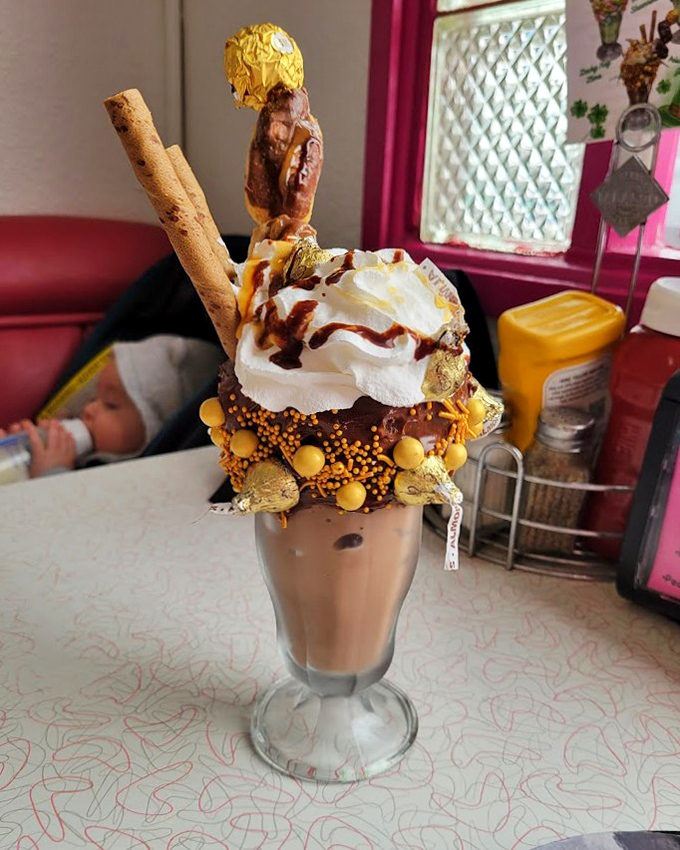 This isn't just a milkshake &ndash; it's a structural engineering marvel topped with enough treats to qualify as its own dessert course.