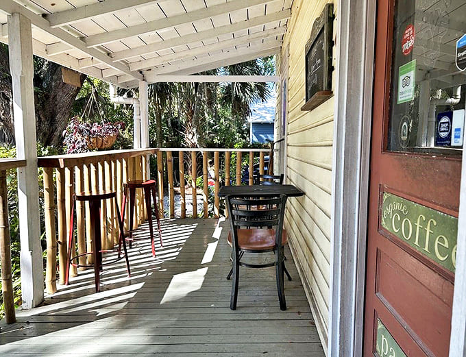 Dappled sunlight creates nature's perfect lighting for this charming porch where coffee tastes better and conversations flow easier.