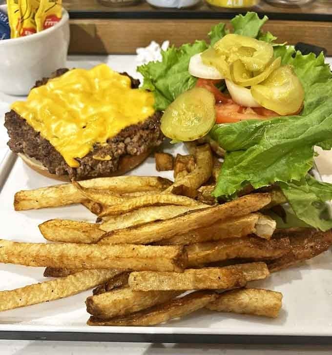 The Native Burger arrives like a work of art &ndash; a hand-formed patty topped with melted cheese on a toasted bun, accompanied by perfectly crisp fries.