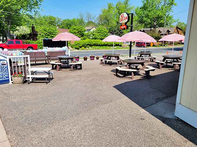 Outdoor seating fills with happy people racing against the sun, all united in the universal struggle of eating faster than ice cream melts.