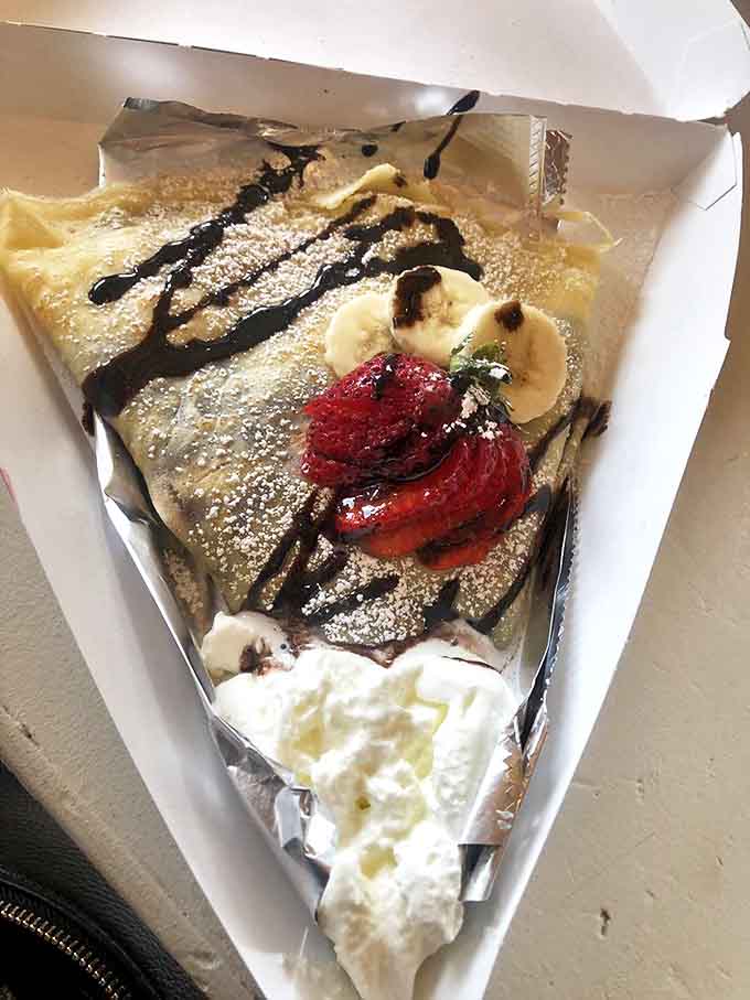 A thin pancake envelope delivering a chocolate-hazelnut love letter to your mouth, with fruit playing delicious supporting roles.