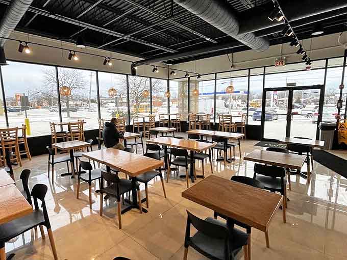 Morning light streams through expansive windows, transforming this thoughtfully designed space into an urban oasis of caffeinated tranquility.