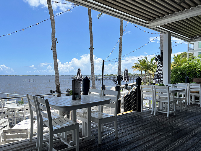 The outdoor patio offers front-row seats to nature's show: boats gliding by as palm fronds dance in the breeze.