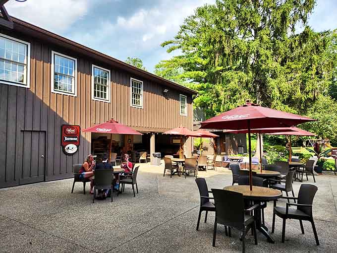 The outdoor patio invites visitors to linger longer under crimson umbrellas, where ice cream melts slightly slower in the dappled shade.
