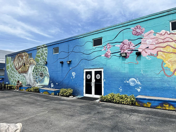 The exterior mural transforms a simple building into an underwater fantasy, inviting passersby into its colorful world.