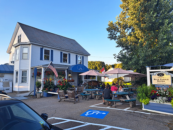 The perfect summer evening spot, picnic tables, umbrellas, and that signature blue awning inviting you to slow down and savor life.