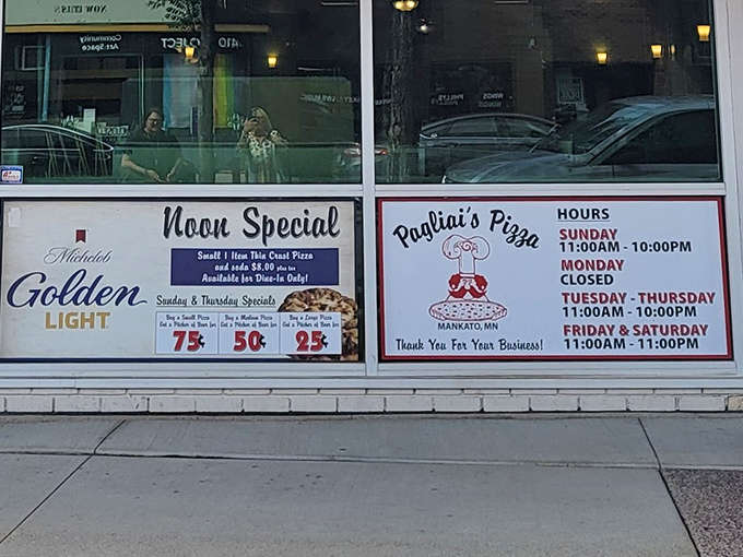 The window displays Pagliai's hours and specials, including their famous noon deal&mdash;a small one-item pizza for dine-in customers only.