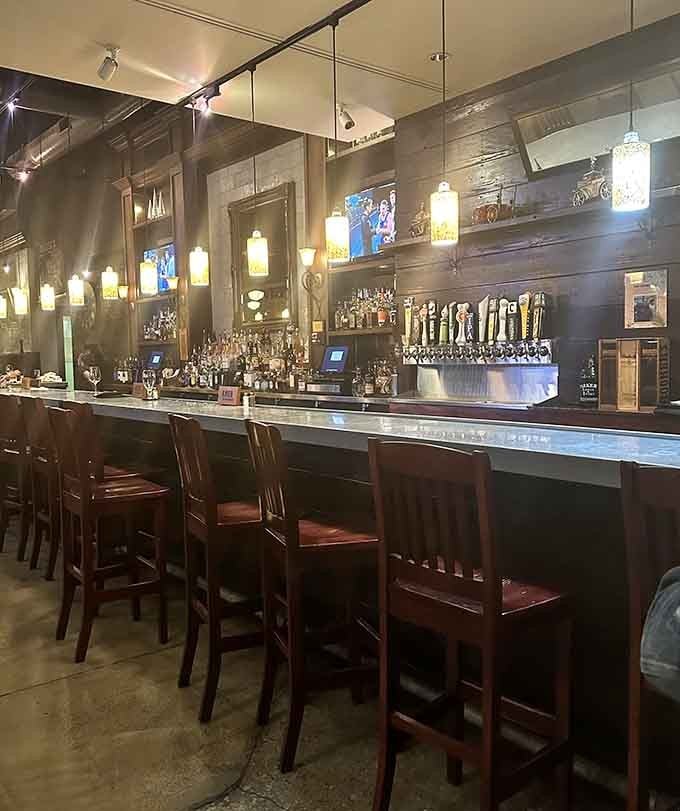 The bar area gleams with polished wood and an impressive tap selection, inviting you to settle in for a spell.