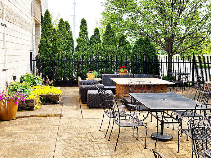 The outdoor patio invites lingering conversations over coffee and dessert, surrounded by greenery that softens the restaurant's brick exterior.