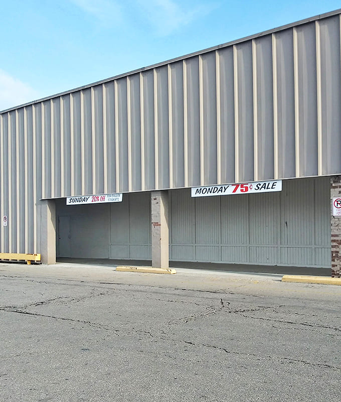 Sunday's 20% off and Monday's 75&cent; sale transform this lot into a bargain hunter's convention. The cracked asphalt has witnessed countless shoppers rushing in with empty arms.