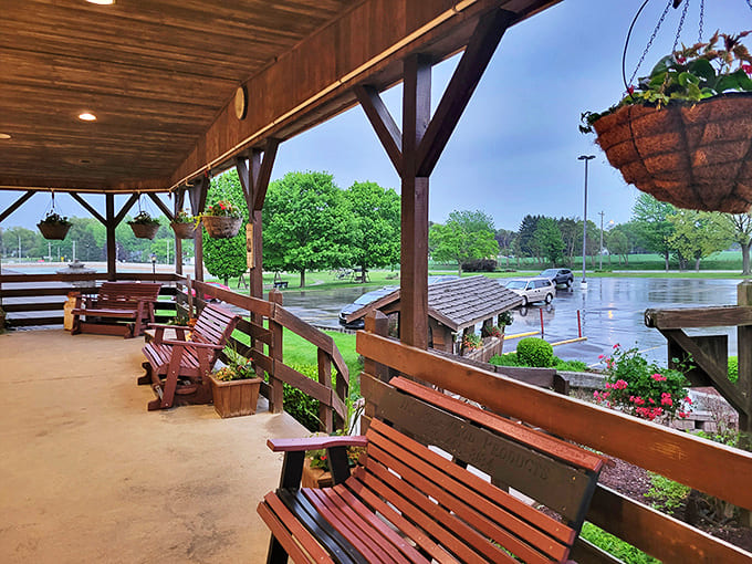 Patio: The covered porch with wooden benches offers the perfect spot to anticipate greatness or digest happiness.