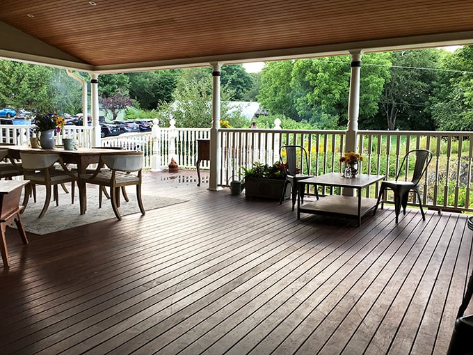 The wraparound porch offers al fresco dining with views of the gardens &ndash; Maine summer evenings don't get more perfect than this.