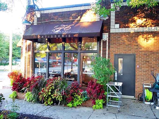 Seasonal plantings frame the entrance like nature's welcome committee, the awning providing shade for outdoor diners on sunny days.