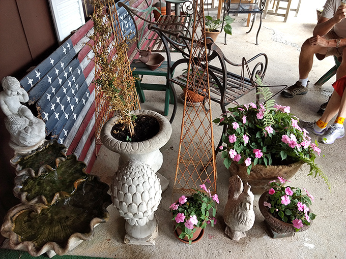 The porch features charming planters and garden ornaments, creating a welcoming space to enjoy your treats while watching Vermont life unfold.