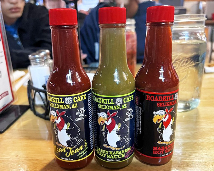 House-made hot sauces line up like colorful soldiers &ndash; "Mean Jean," green habanero, and "Roadkill Special" &ndash; each bottle promising to elevate your meal with liquid fire.