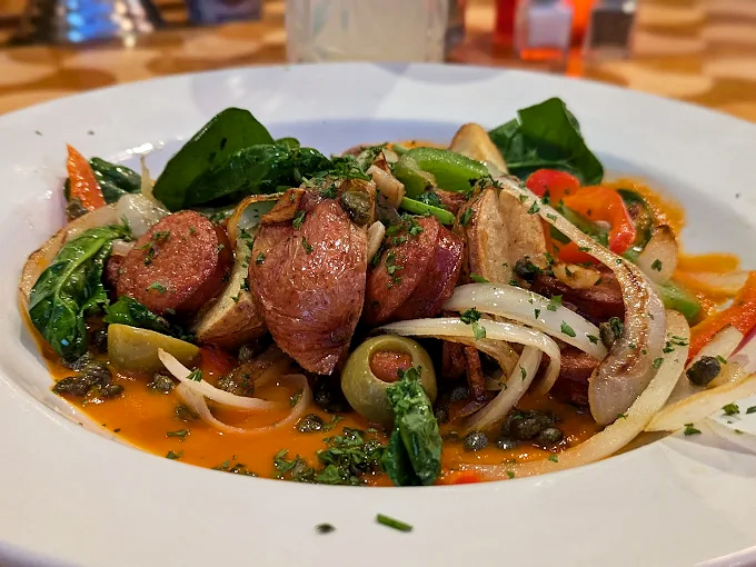 Sausage and peppers elevated from street food to symphony. The sauce isn't just tomato basil&mdash;it's a sonnet to summer gardens.