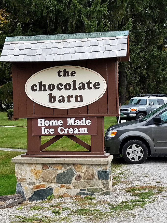 Not all heroes wear capes—some wear wooden signs. This roadside beacon guides chocolate pilgrims to their sweet destination with rustic charm.