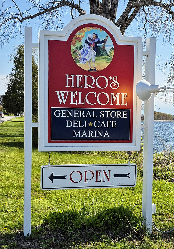 The iconic Hero's Welcome sign stands proudly by Lake Champlain, a beacon for hungry travelers and boaters seeking sandwich perfection.