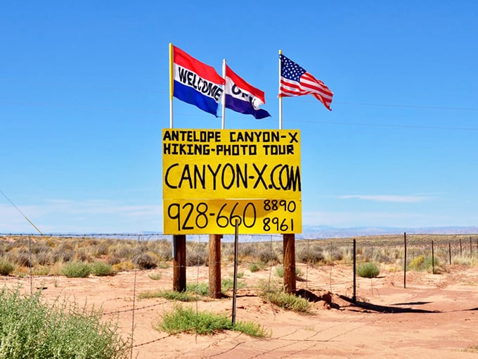 A tour sign for Antelope Canyon stands against the desert backdrop, one of the few concessions to tourism along this remarkably undiscovered route.