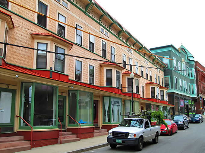 Colorful historic buildings line the sloping street, their storefronts offering treasures from antiques to artisanal Vermont cheeses.
