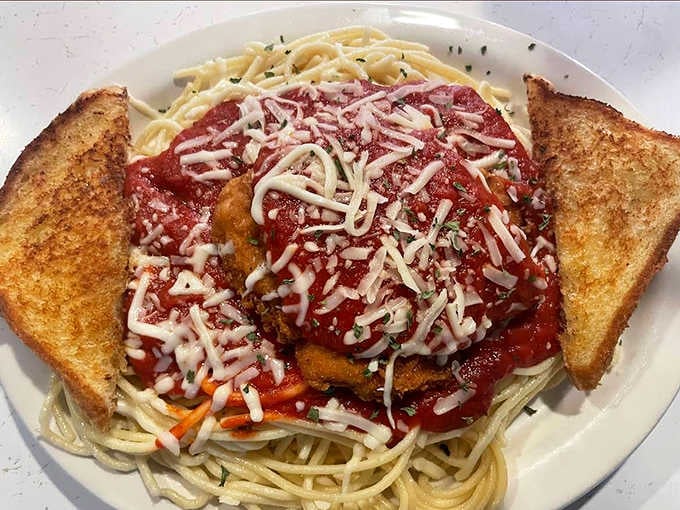 Spaghetti topped with a golden chicken cutlet and melting cheese &ndash; Italian-American comfort food that doesn't apologize for being exactly what it is.