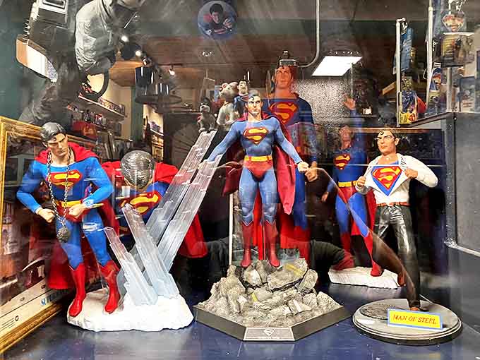 These statues and action figures represent Superman through various eras and styles, standing together like a superhero support group discussing their different costume choices over the years.