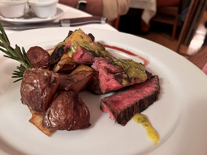 This plate showcases the kitchen's artistry – slices of perfectly cooked steak alongside roasted potatoes that have achieved golden-brown perfection.