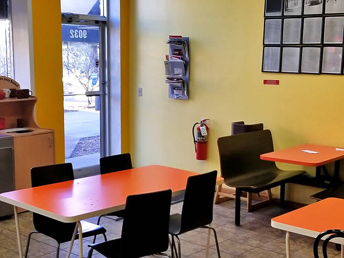 The seating area waits patiently for its next visitors, a simple stage for countless morning rituals and sugar-fueled conversations.