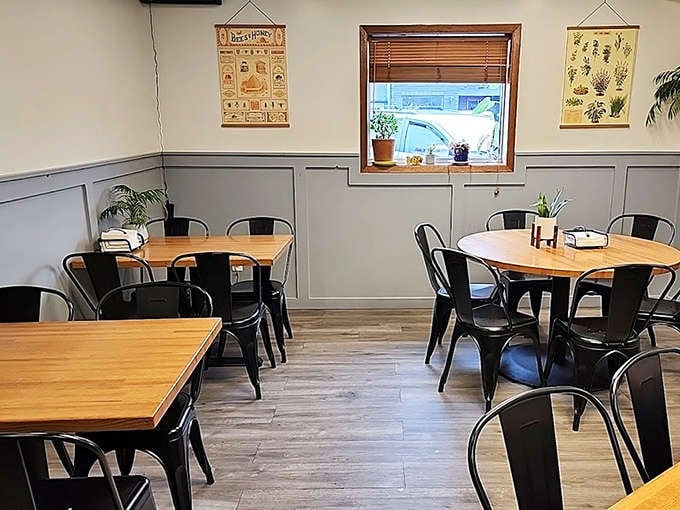 Simple wooden tables and black chairs create an unpretentious backdrop that lets the food take center stage &ndash; notice the vintage-inspired educational posters adding character.