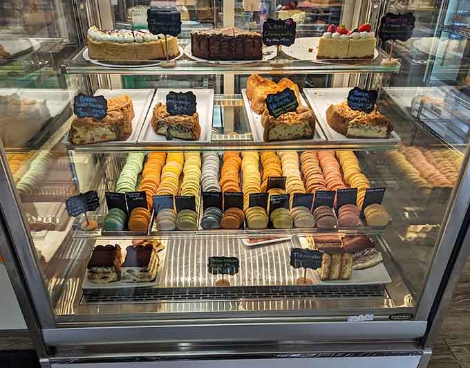 The display case showcases layers of cakes, rows of macarons, and enough sweetness to power a small city for weeks.