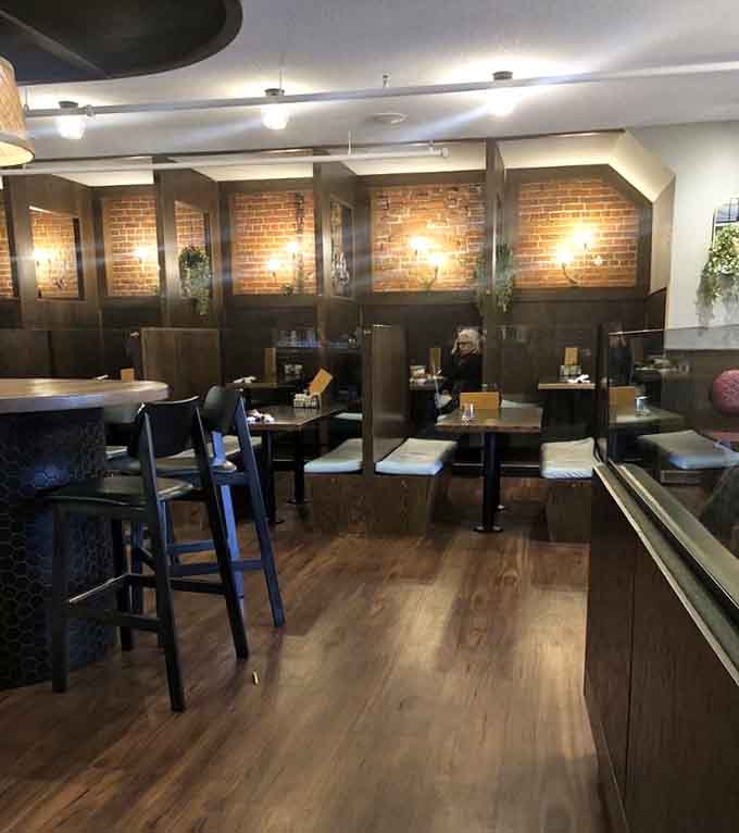 Private booth seating with warm lighting offers the perfect spot for intimate conversations over plates of Minnesota's finest comfort food.