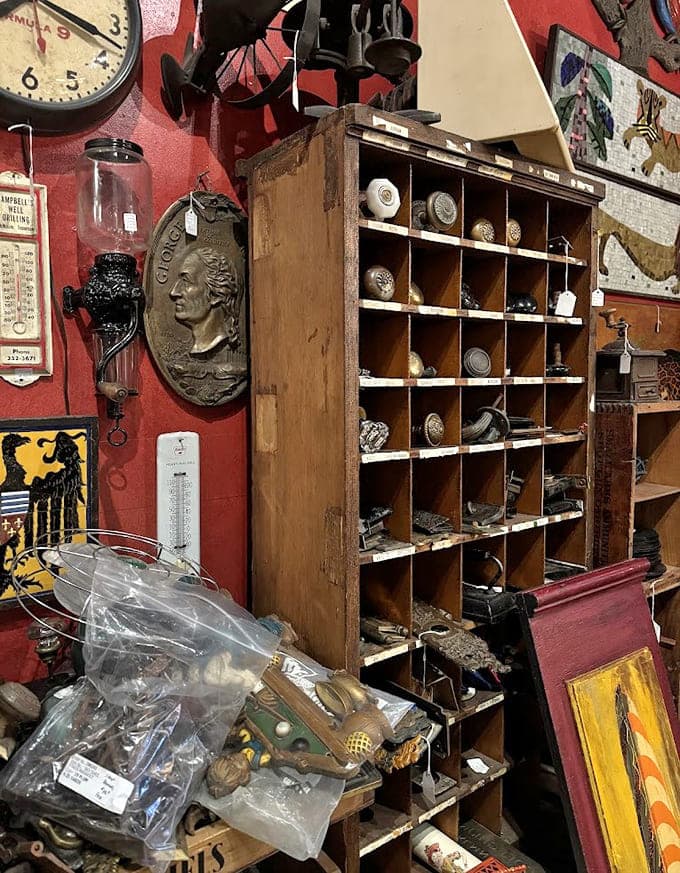 The basement level where quirky meets practical, and vintage signs share space with doorknobs that once opened doors to unknown stories.