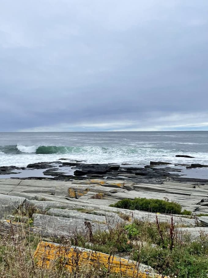 Waves crash against ancient rocks in an endless performance that's been running since long before restaurants were invented.