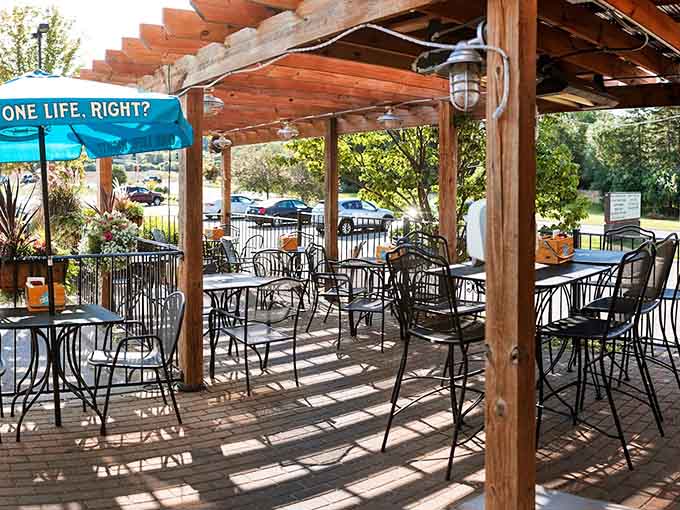 The outdoor patio offers fresh air dining under a pergola, where Minnesota summers taste even better with good food and cold drinks.
