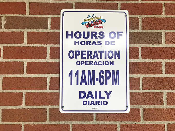 The hours sign &ndash; both a promise and a deadline for summer fun, with bilingual instructions ensuring everyone knows when to arrive.