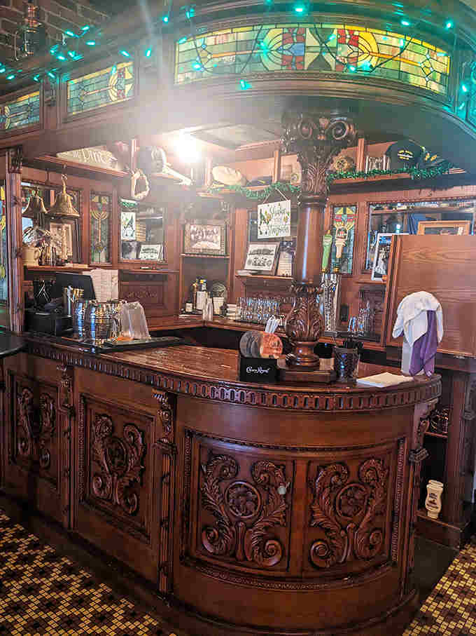 Ornate woodwork and stained glass transform this bar into a cathedral of spirits, where the bartender presides like a high priest of hospitality.