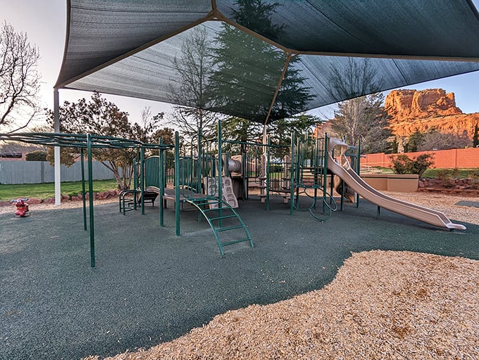 The community playground sits in the shadow of towering buttes, where kids burn energy while parents marvel at raising children in such magnificent surroundings.