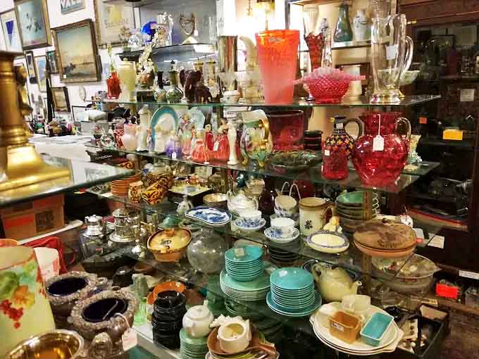 Kitchen treasures stacked with care &ndash; turquoise Pyrex bowls and delicate teacups that survived decades of family dinners now waiting for your table.
