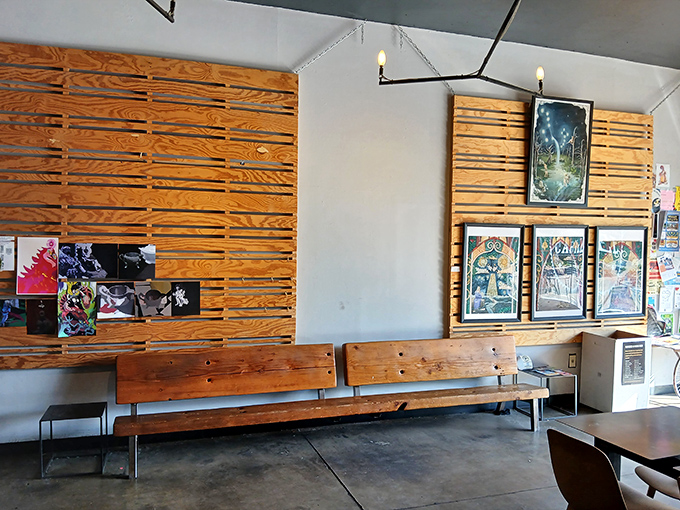 Wooden slat walls double as gallery space, showcasing local artists and adding warmth to the minimalist aesthetic.