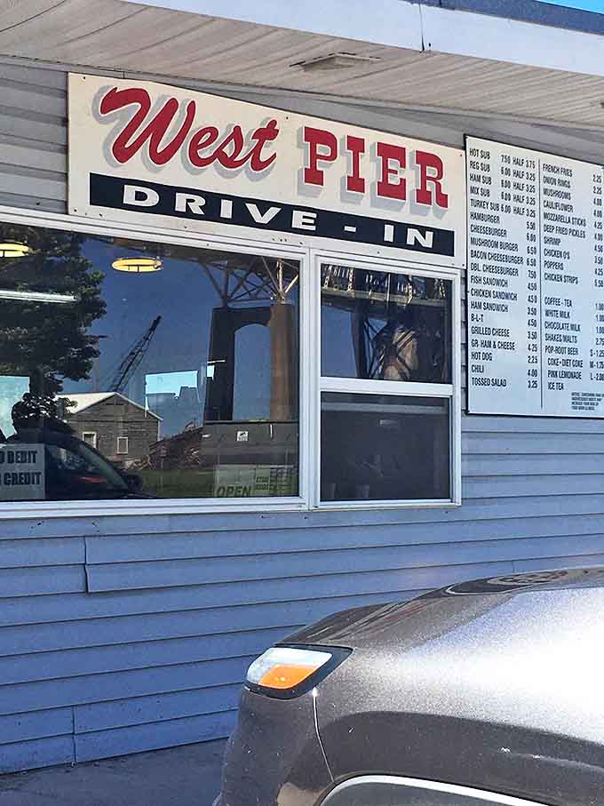 The iconic West Pier Drive-In sign promises simple pleasures and delivers extraordinary satisfaction, a beacon for burger lovers throughout Michigan.