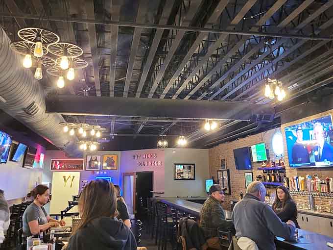 Another angle reveals the spacious layout and multiple TV screens for game-day gatherings.