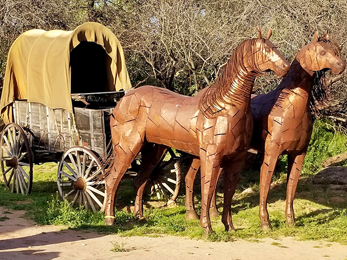 An artistic wagon sculpture pays homage to the area's pioneer history, standing as a rustic reminder of those who first traveled these lands.