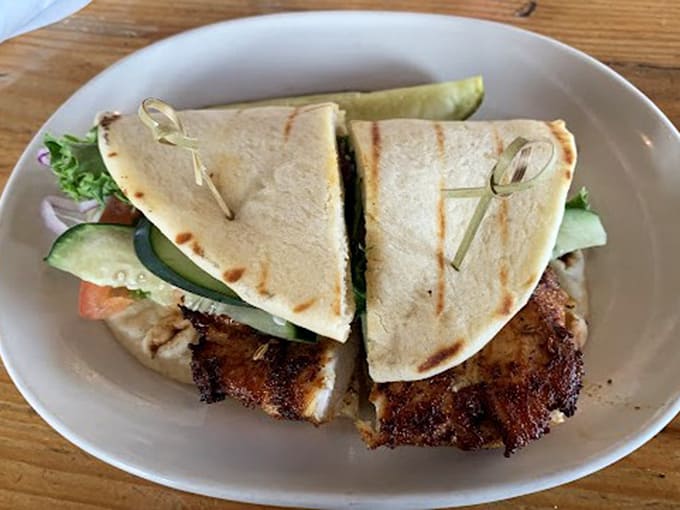 This isn't just a sandwich&mdash;it's architecture. Grilled pita cradles perfectly seasoned chicken and fresh veggies, secured with wooden picks like delicious structural support.