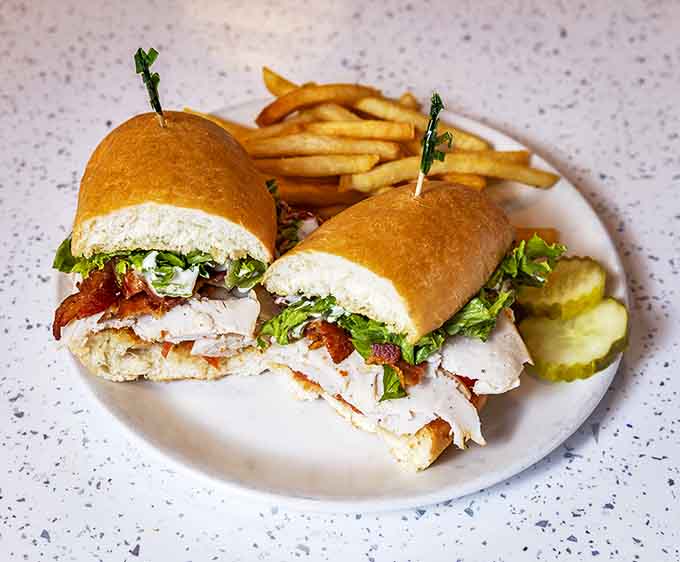 This club sandwich doesn't just stack ingredients &ndash; it builds a skyscraper of turkey, bacon, and veggies that requires strategic eating techniques.