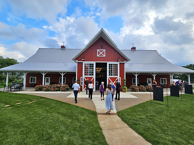 The barn entrance welcomes visitors with rustic elegance, promising an experience that transcends ordinary dining.