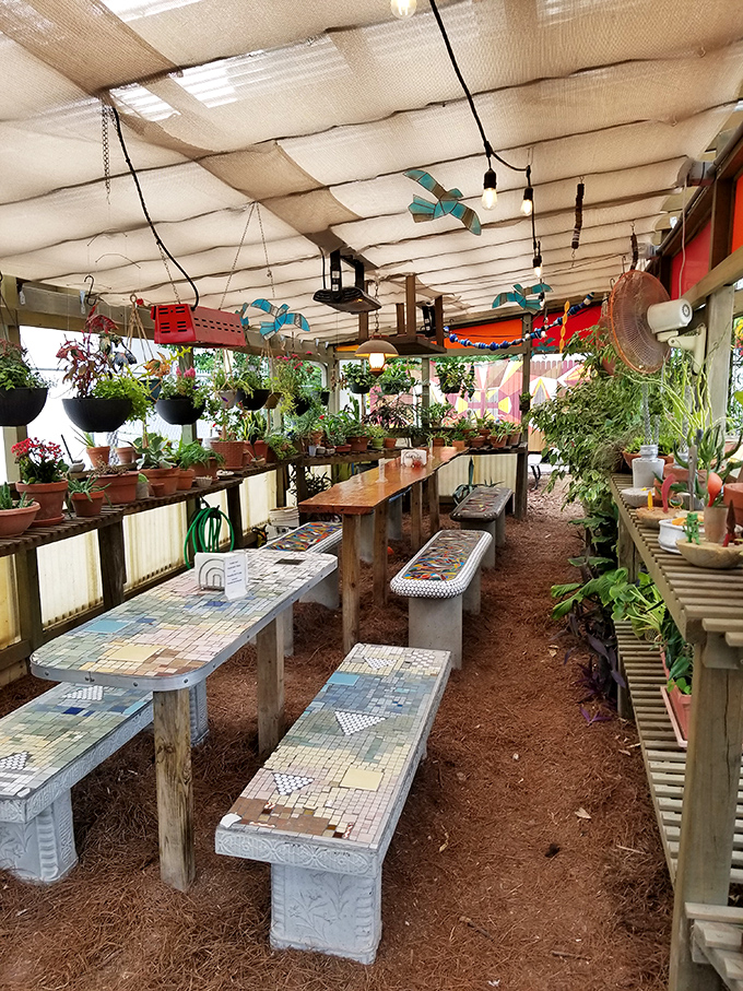 The garden seating area offers a tranquil escape, with mosaic tables and hanging plants creating a secret hideaway for outdoor dining.