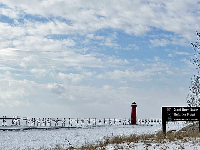 Winter's white blanket transforms the pier into a snow-covered pathway to the lighthouse, an adventure for the brave-hearted.