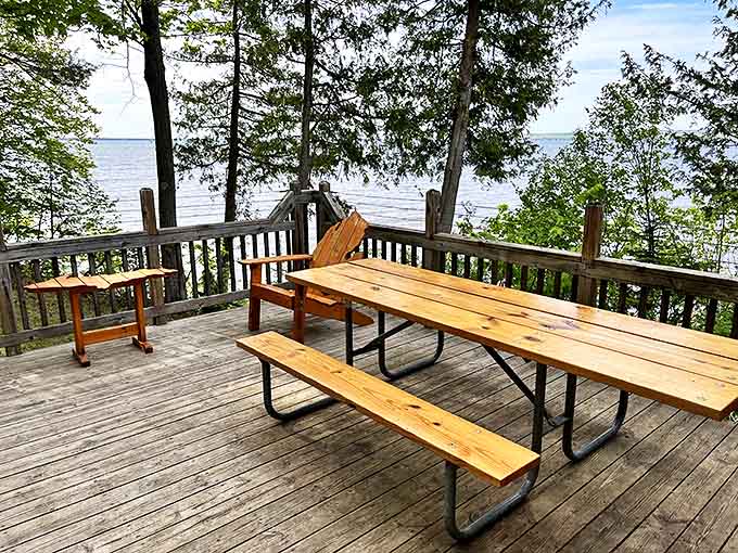 Picnic perfection: This lakeside deck transforms simple sandwiches into gourmet experiences through the magic of that million-dollar Michigan view.