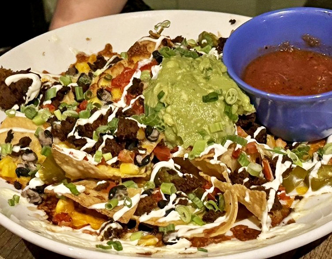 Nachos piled so high they defy gravity, topped with all the good stuff. This isn't a starter, it's a commitment.