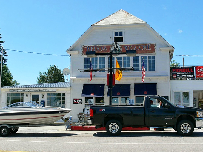 Summer sunshine bathes the iconic storefront, where boats and cars gather like pilgrims at a delicious shrine.